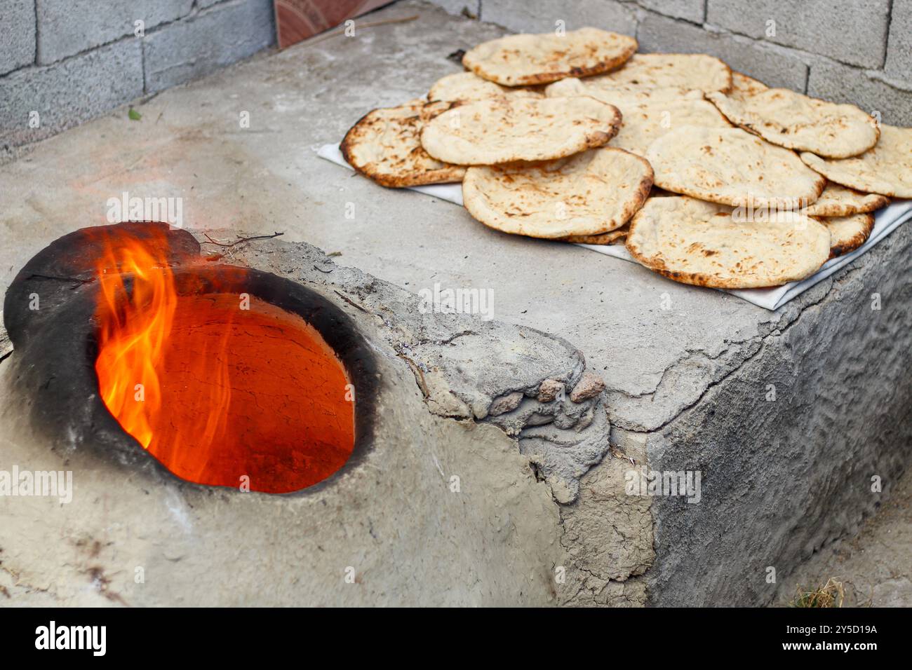 Baking bread in a tandoor oven using the traditional method in Hatay ...