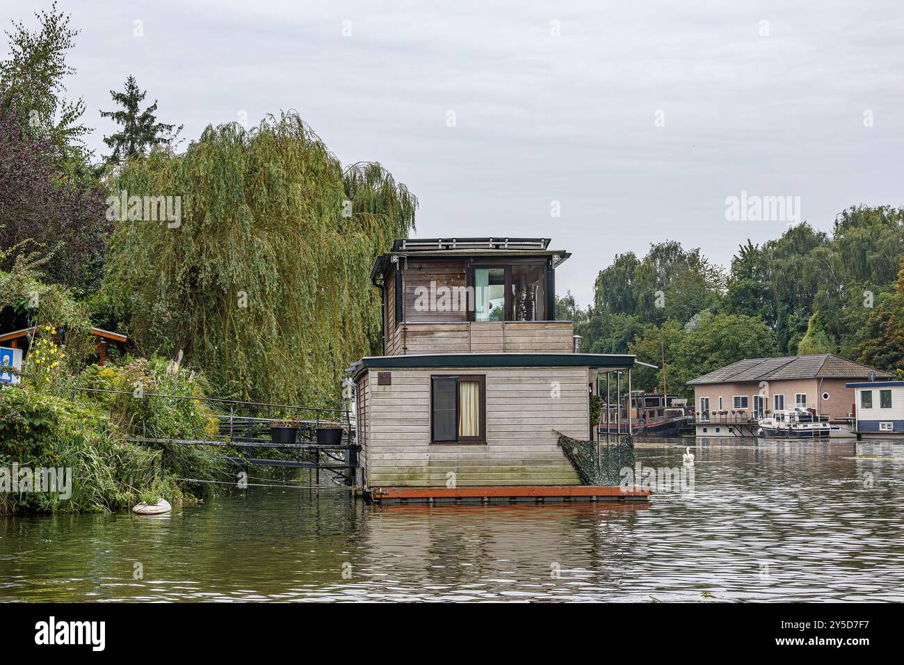 Houseboat moored in shipping canal outside city of Maastricht, wooden ...