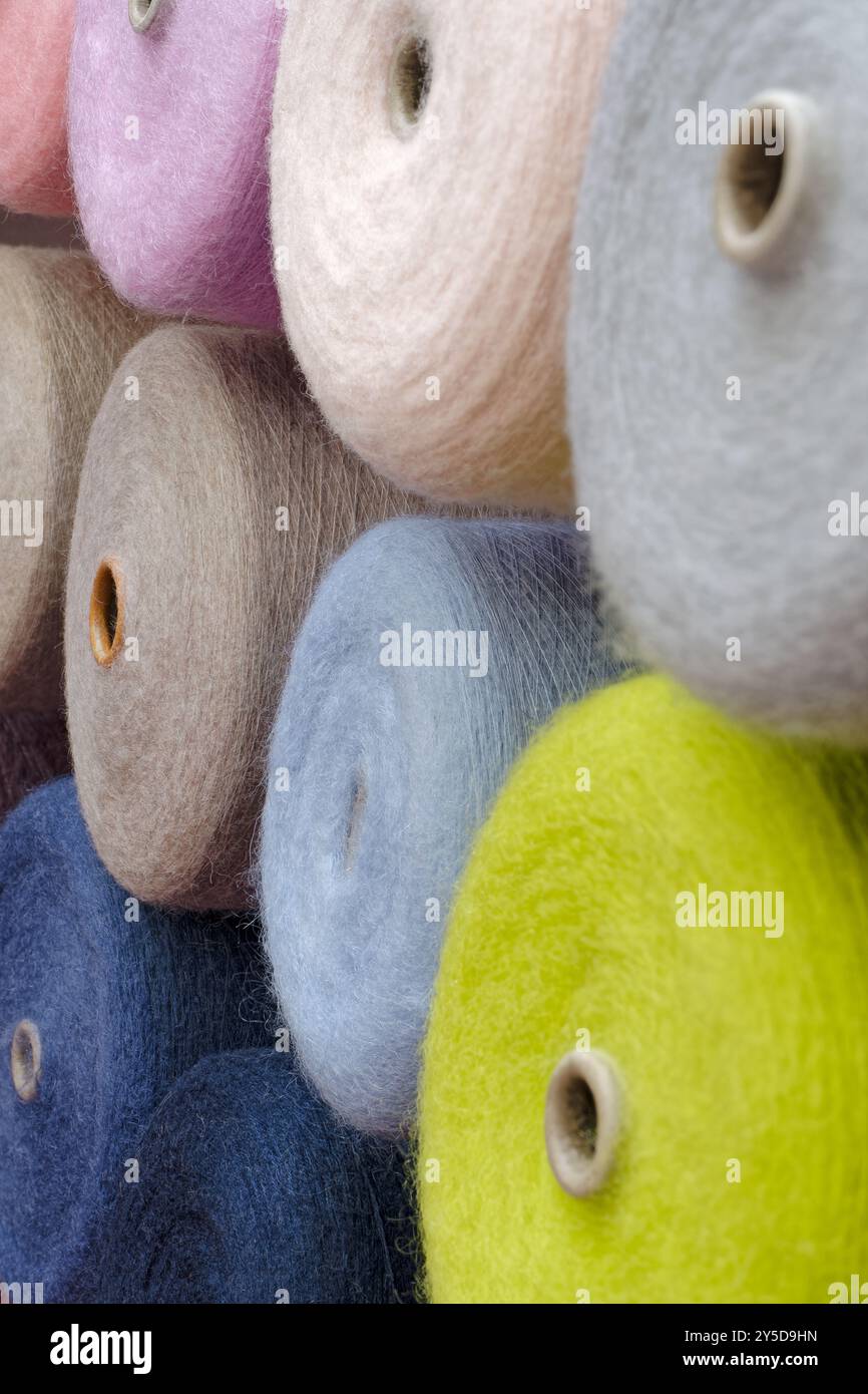 Spools of multi-coloured wool threads, abstract textile industry ...