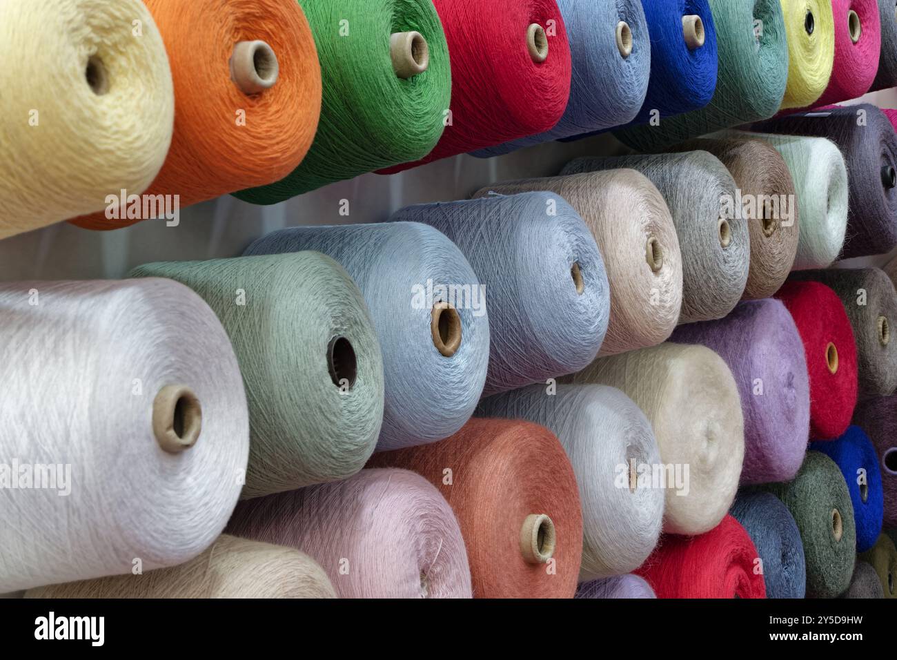 Spools of multi-coloured wool threads, abstract textile industry ...