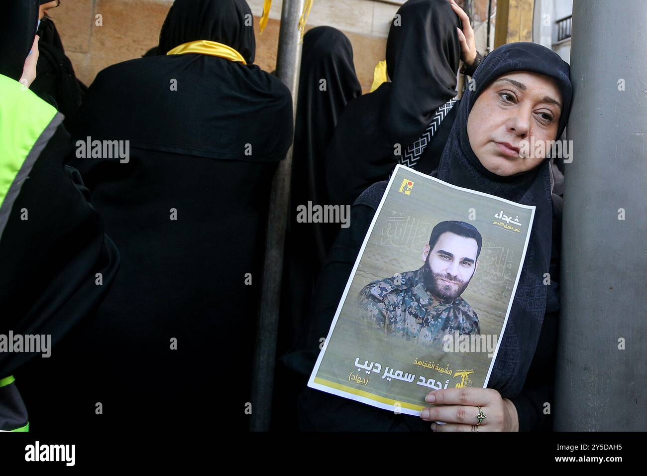 Beirut, Lebanon. 21st Sep, 2024. A woman holds the picture of one of ...