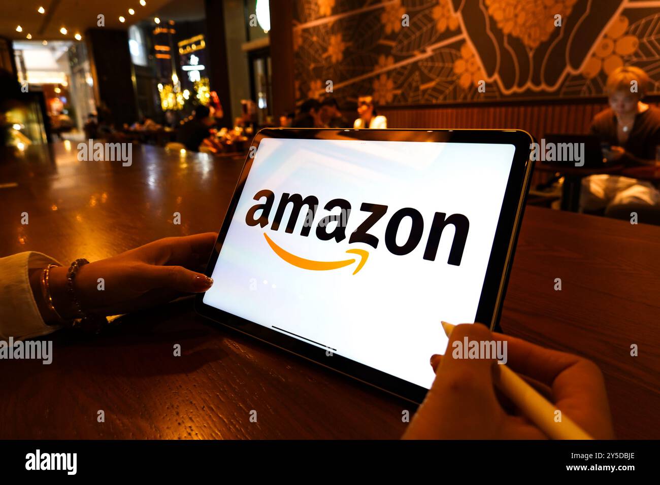 In this photo illustration, an Amazon logo is displayed on the screen ...