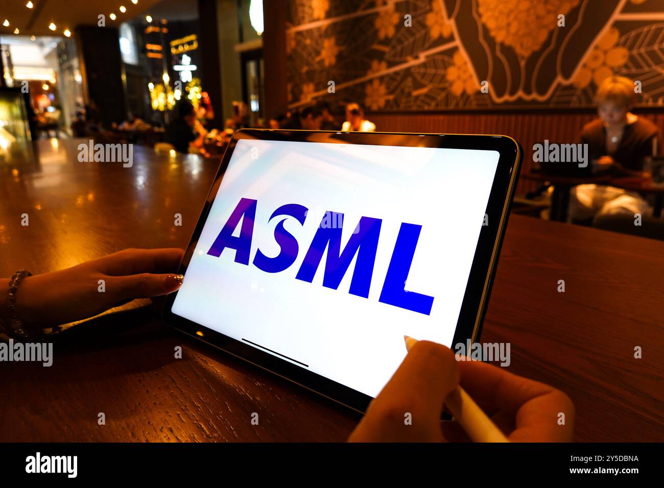 In this photo illustration, an ASML logo is displayed on the screen of ...