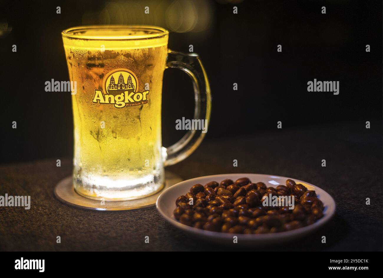 Glass of popular cambodian angkor beer draft with peanuts in bar Stock ...