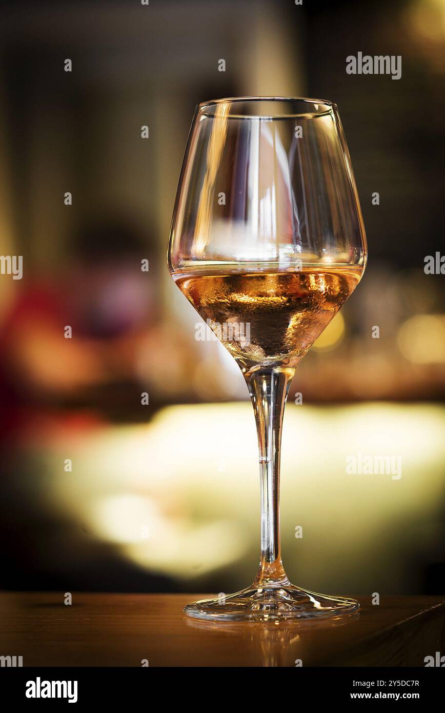 Glass of rose wine on bar counter at night Stock Photo - Alamy
