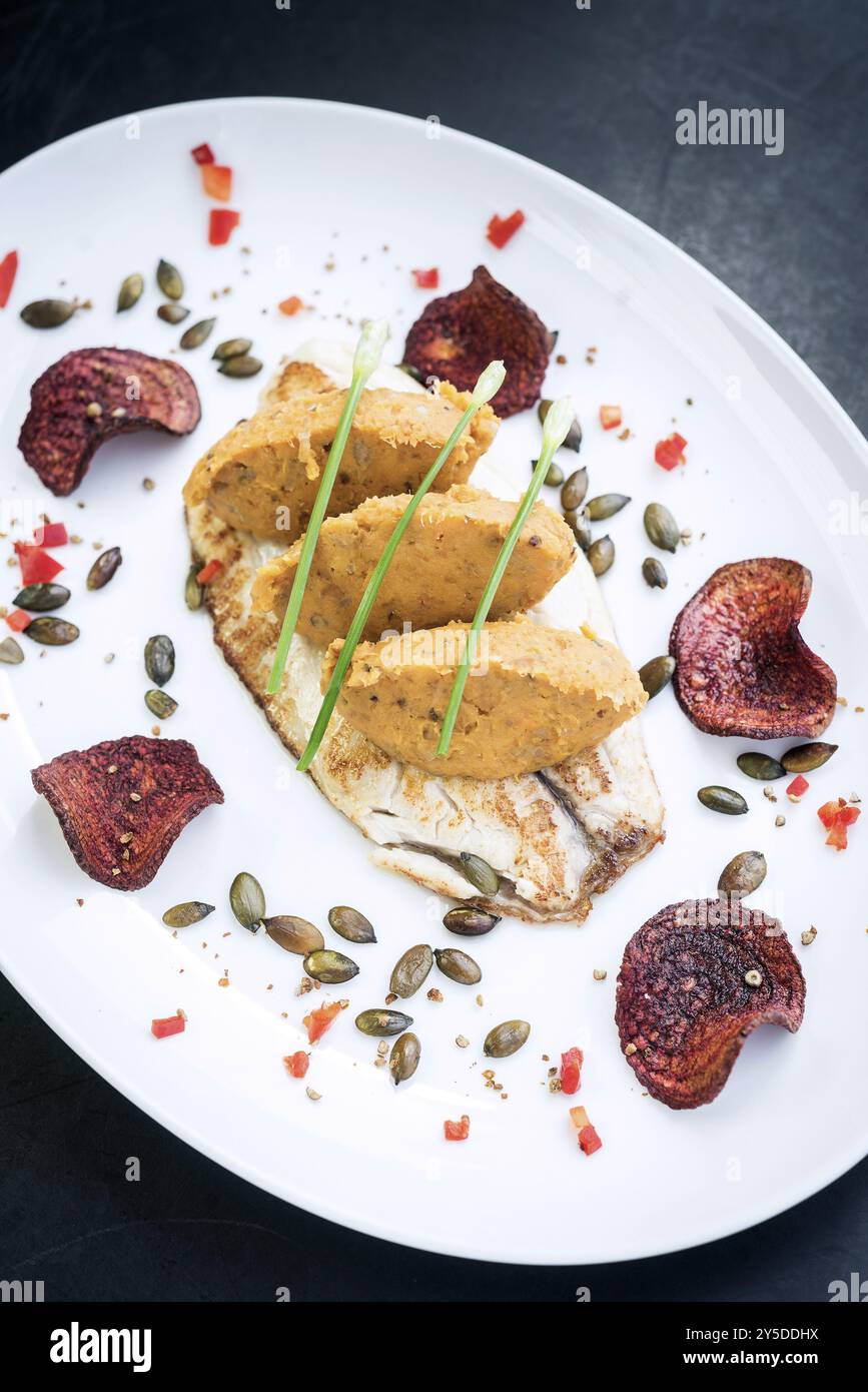 Gourmet fish fillet with chickpea curry puree and beetroot chips meal ...