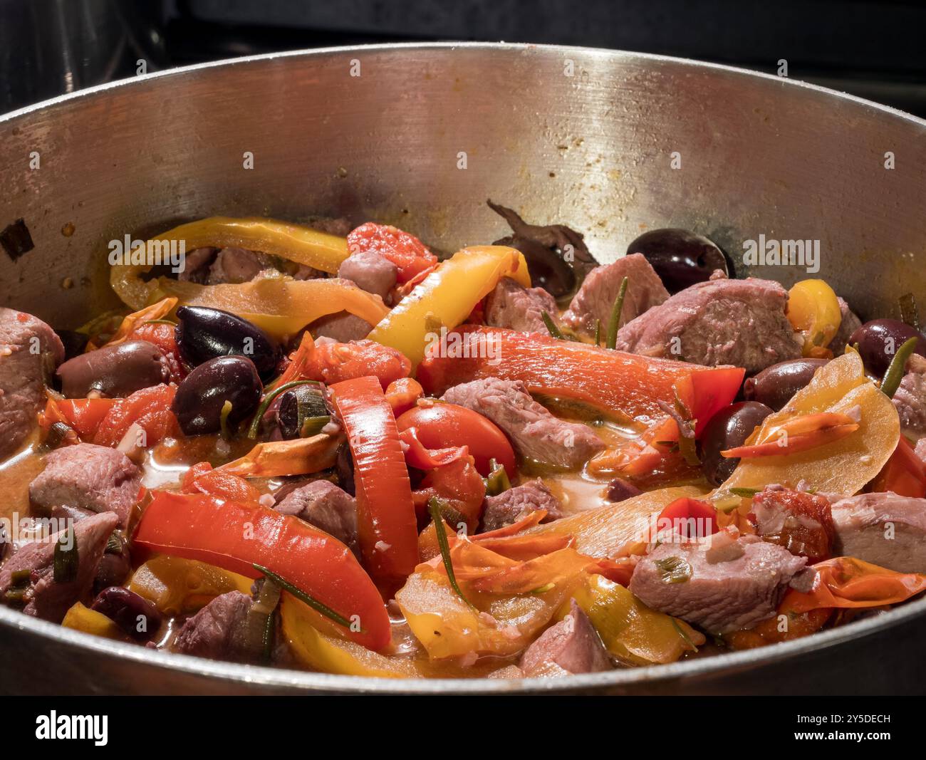 A hearty skillet dish with tender chicken, fresh bell peppers, ripe ...