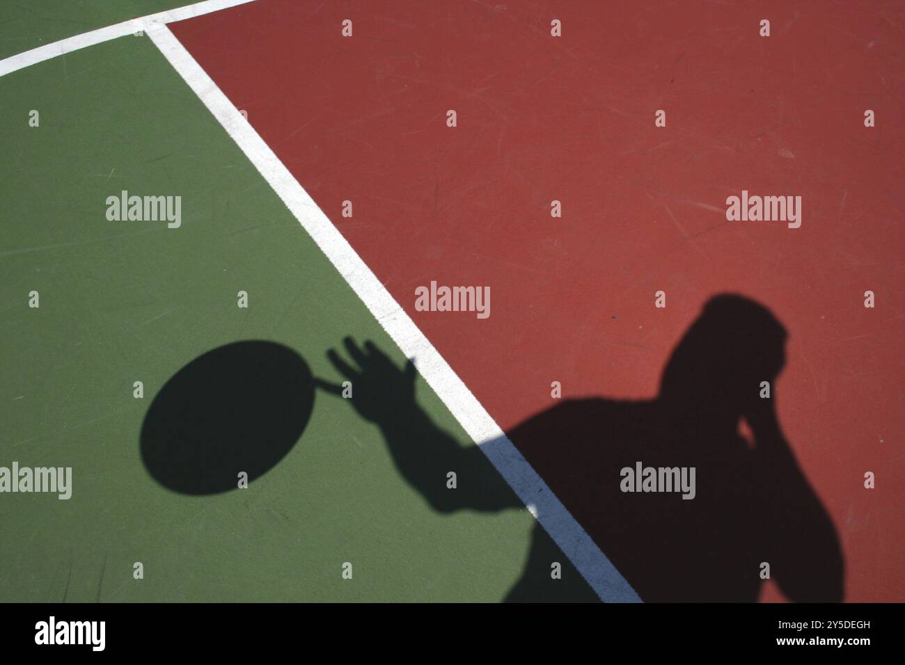 A Basketball shadow player dribbling on red and green court Stock Photo ...