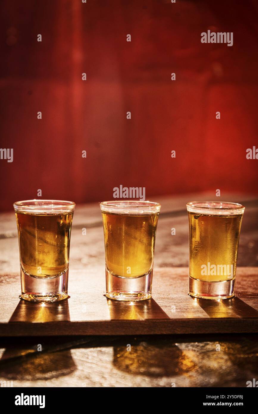 Whisky shots in cozy red bar interior Stock Photo - Alamy
