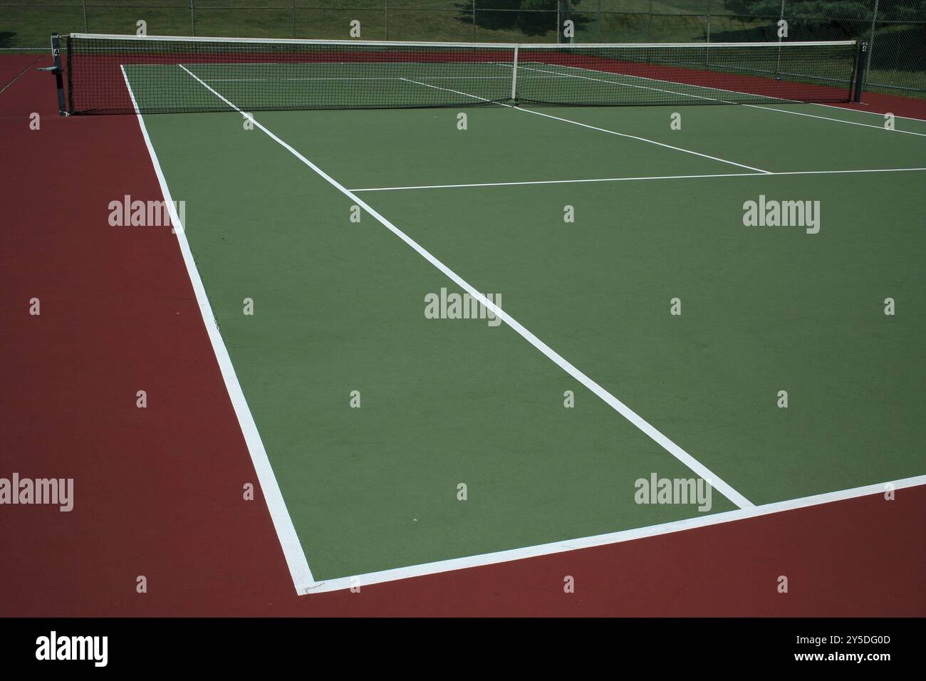 A empty green Tennis Court with net Stock Photo - Alamy