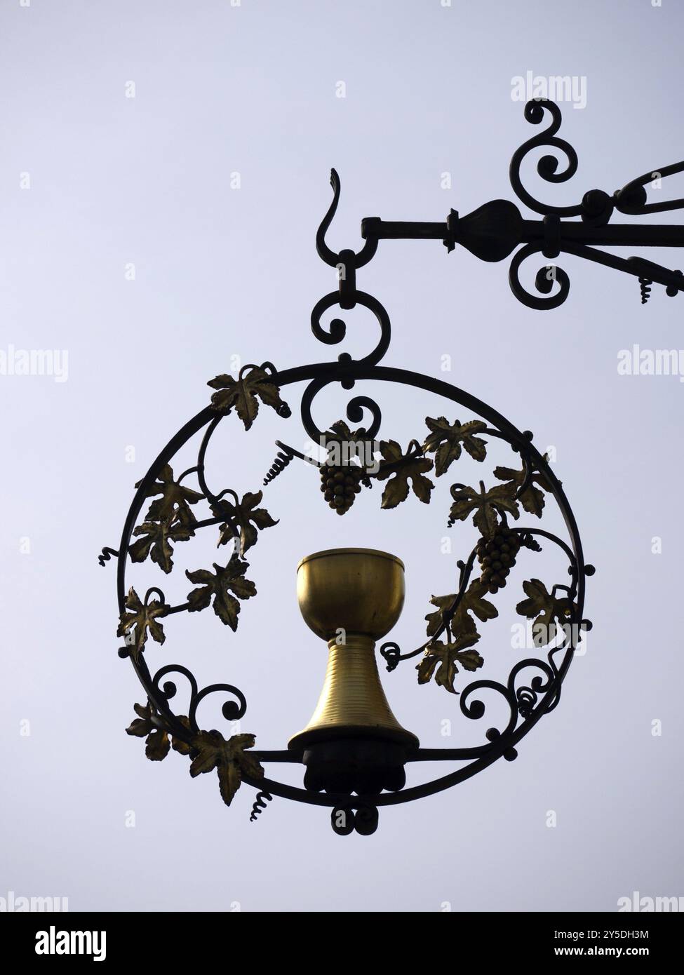 Wrought iron shop sign with wine glass and vines Stock Photo - Alamy
