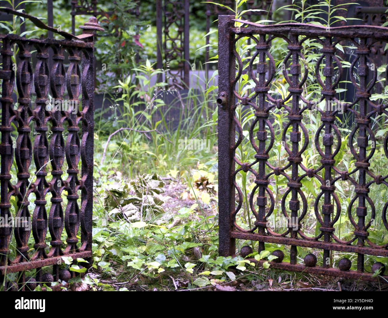 Open wrought-iron gate Stock Photo - Alamy