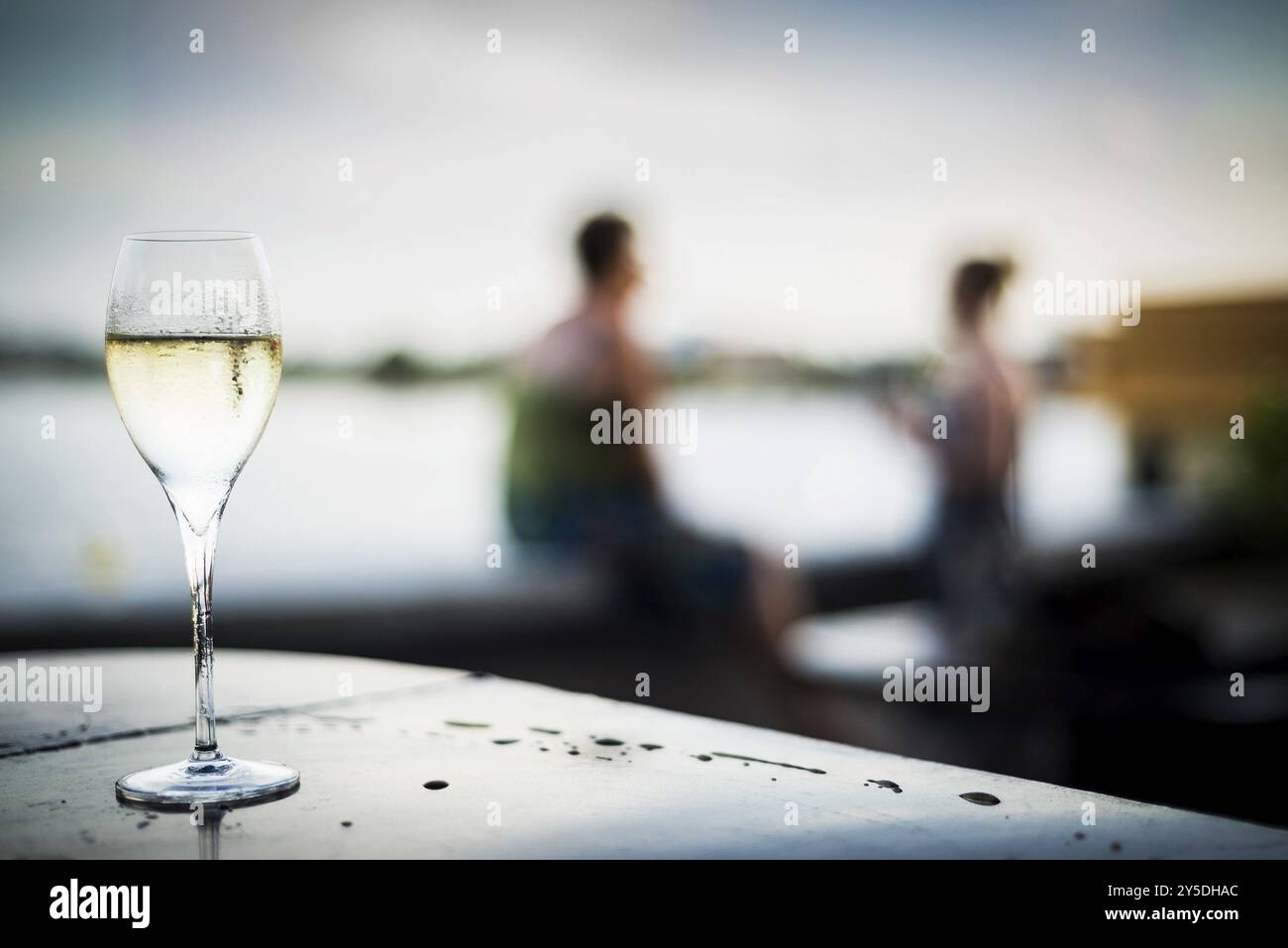 Glass of sparking champagne wine at modern outdoor bar at sunset Stock ...