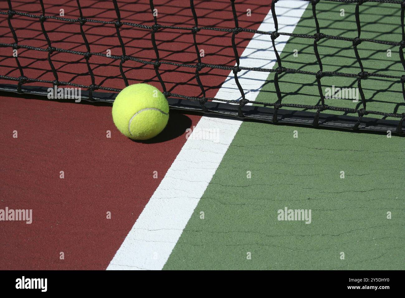 A Tennis Ball out of bounds with white line and net Stock Photo - Alamy