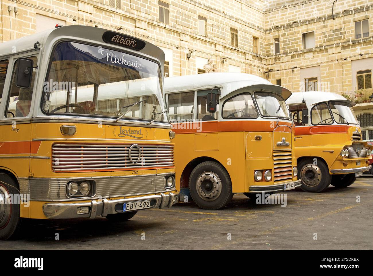 Vintage yellow british buses in valetta malta Stock Photo - Alamy
