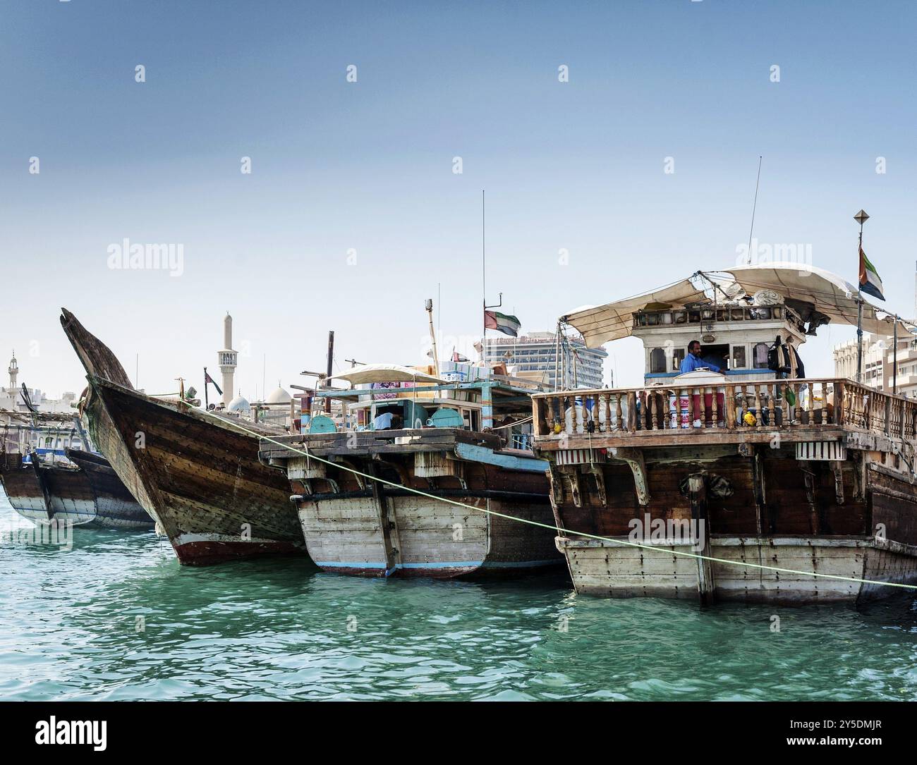 Traditional old arabian wood dhow boats in deira harbour of dubai port ...