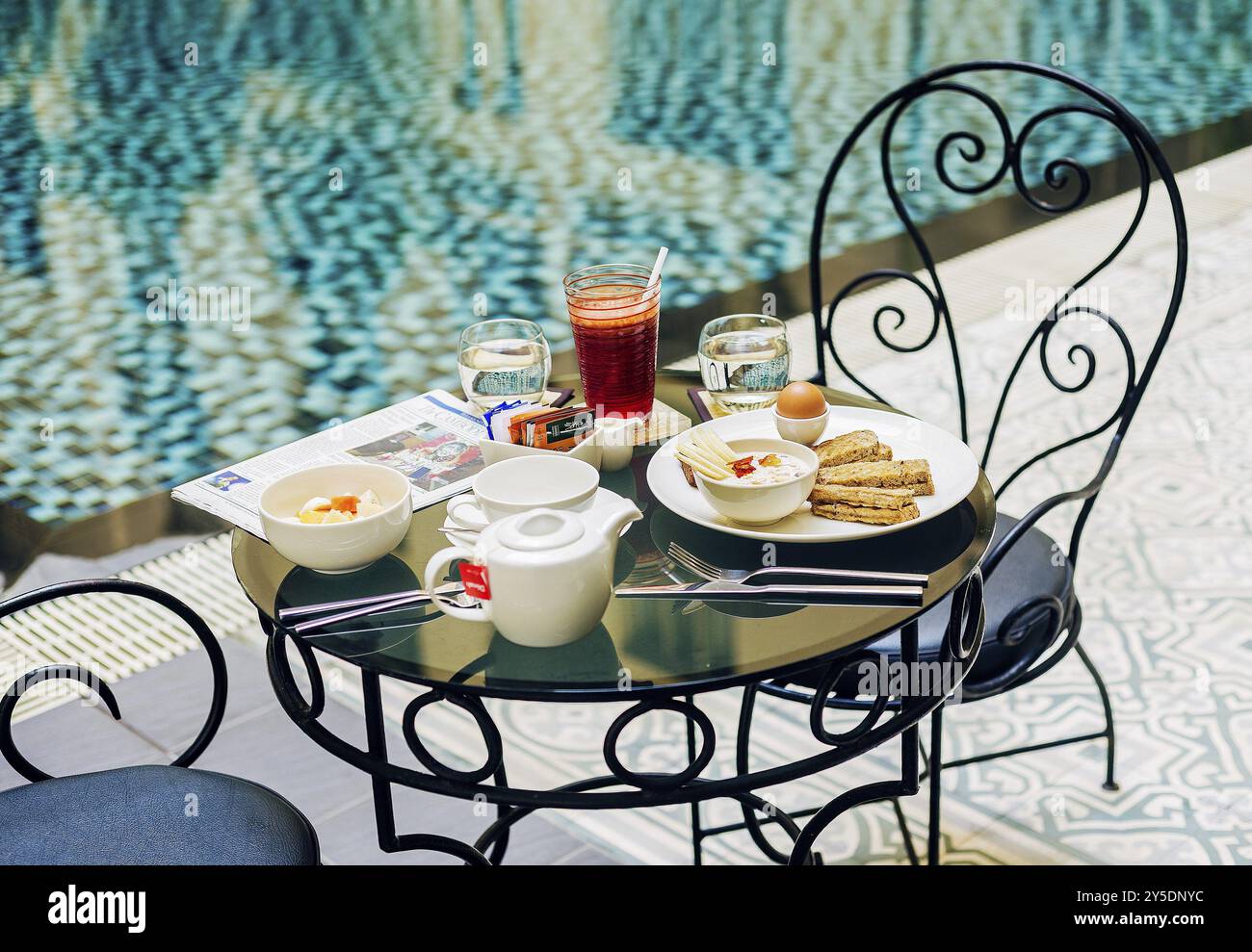 Gourmet continental breakfast table set at luxury hotel poolside Stock ...