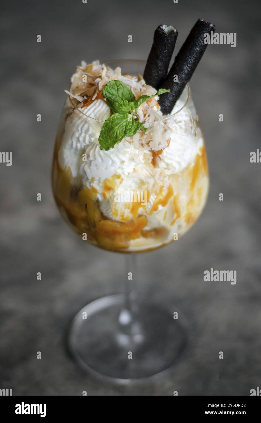 Gourmet organic coconut and caramel with ice cream sundae dessert in ...