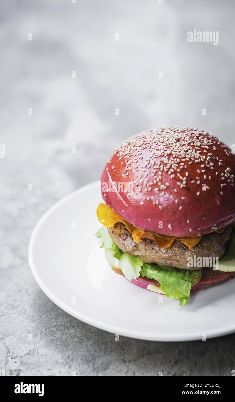 Gourmet trendy modern novelty chicken burger in beetroot bun Stock ...