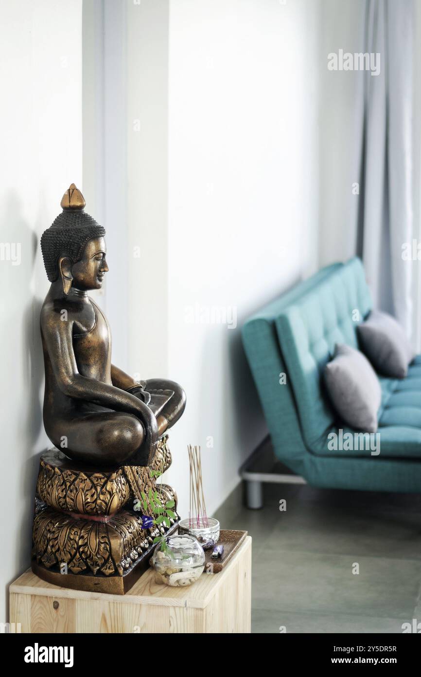 Bronze buddha statue interior design detail in modern asian home living ...