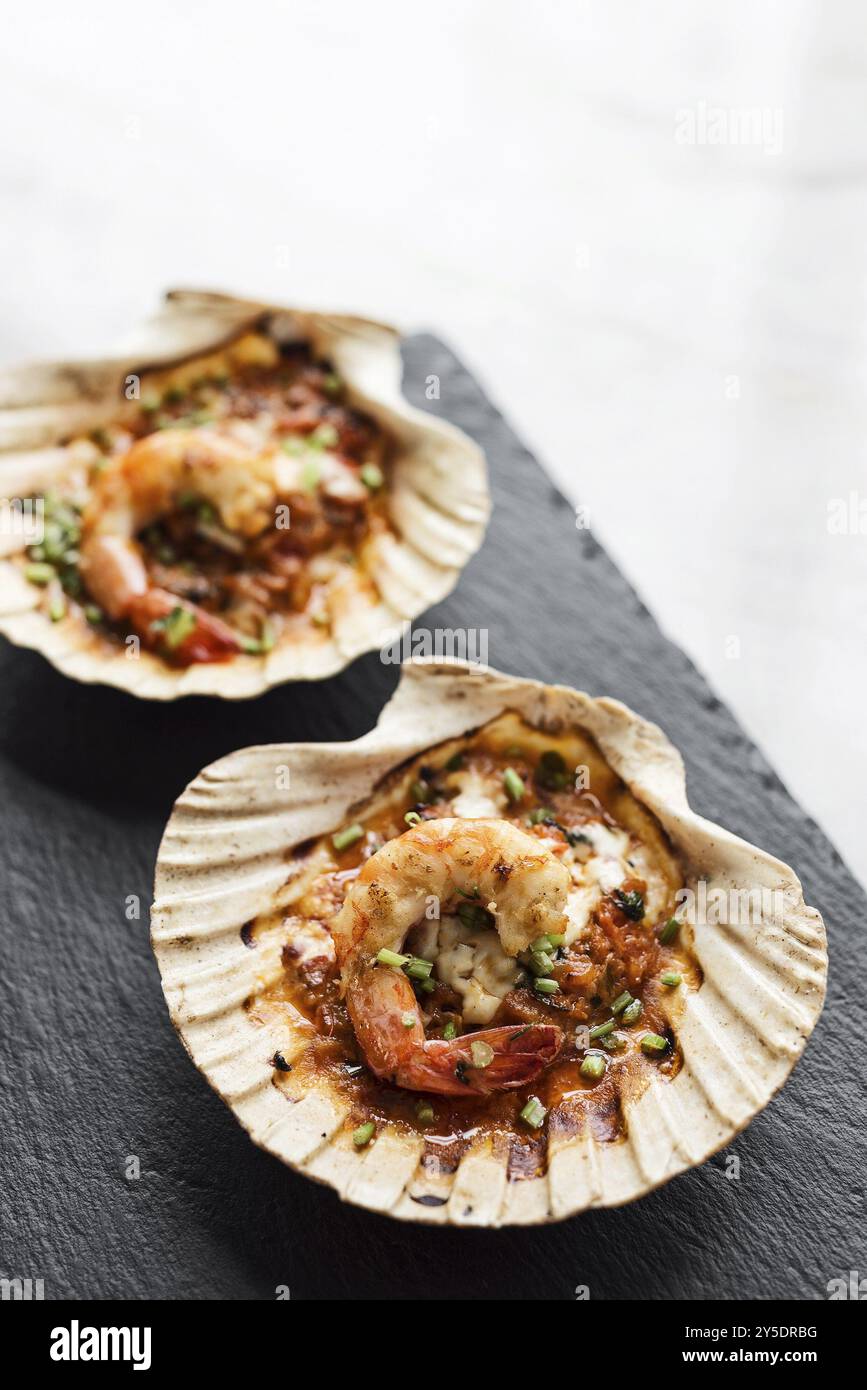 Gourmet cuisine baked king prawns in spicy tomato and herb sauce Stock ...