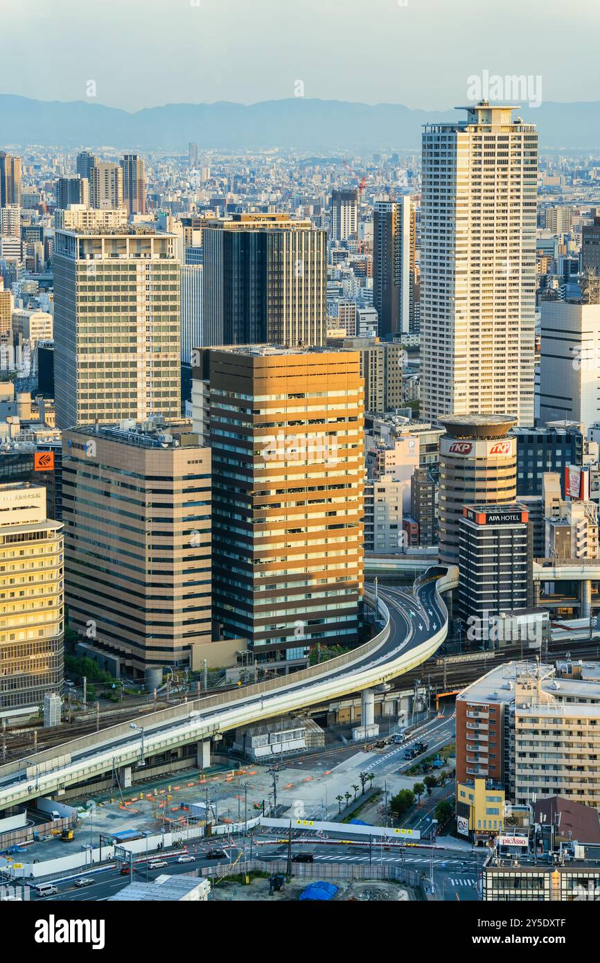 Aerial scenic view of Osaka skyline at sunset. Modern glass skyscrapers ...