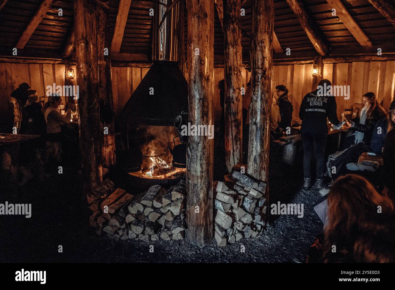 Fire burning inside wooden Saami hut near Tromso, Norway in the arctic ...