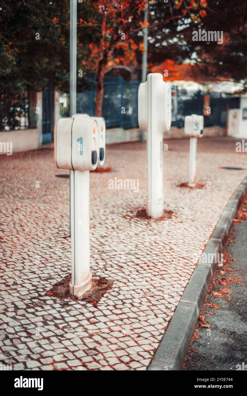 Vertical shot of an electric vehicle charging stations with numbered ...