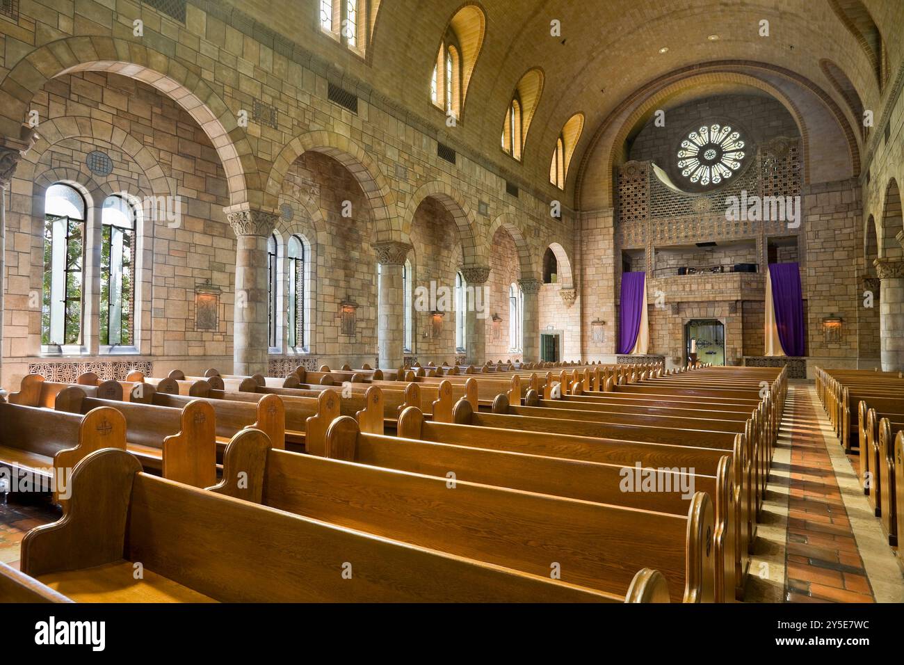 Interior of romanesque church looking toward choir loft and rose window ...