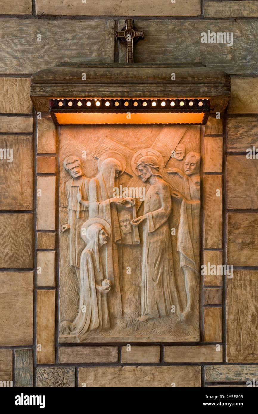 Carved stone station of the cross on church wall Stock Photo - Alamy
