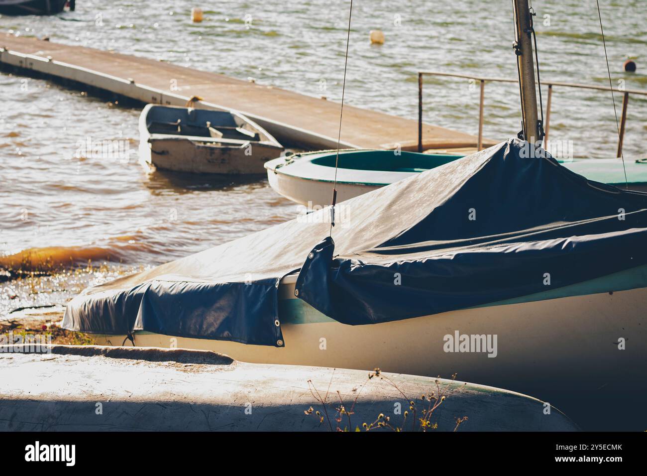 Boats Resting on the Shore of a Calm Reservoir Stock Photo - Alamy