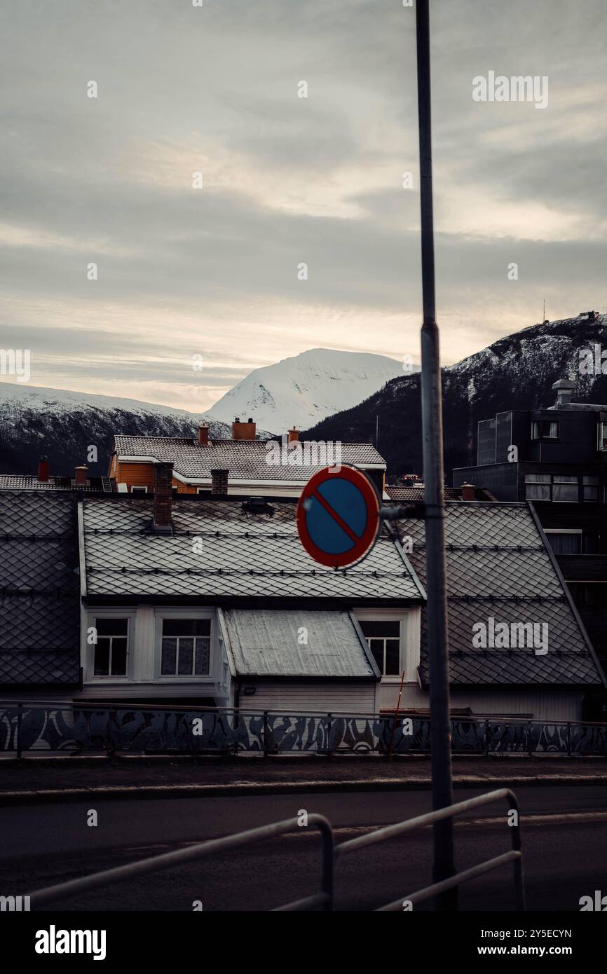 Snowy mountain in the arctic over Tromso city skyline in autumn in ...
