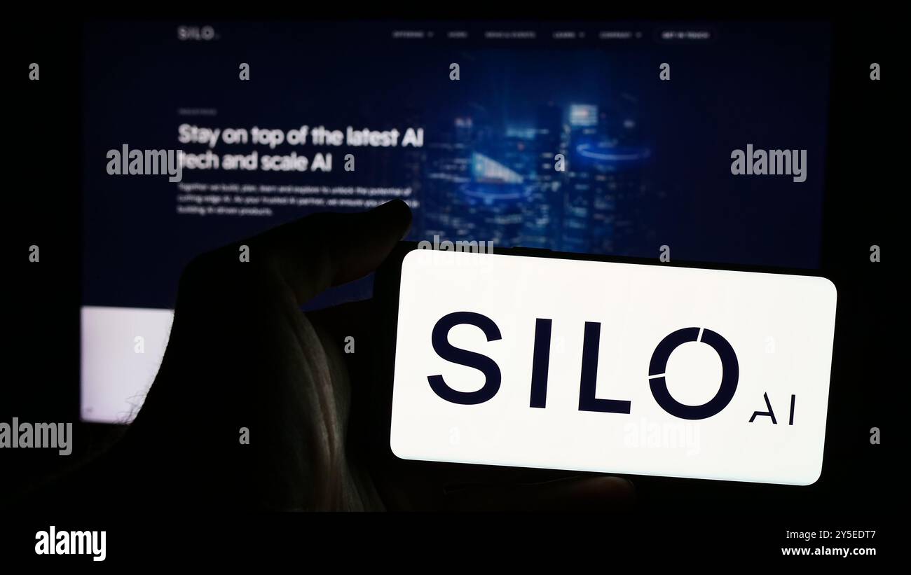 In this photo illustration, a person is holding a mobile phone with the ...