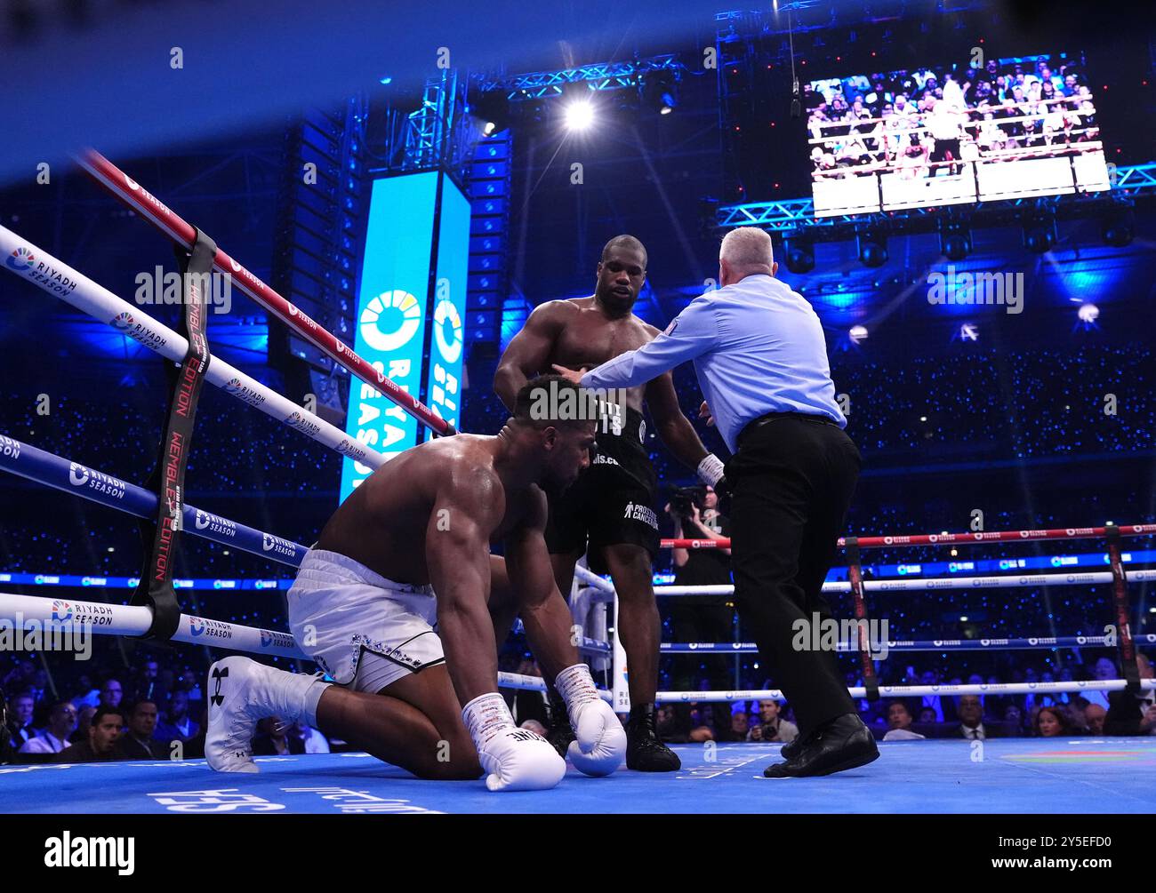 Daniel Dubois (centre) knocks down Anthony Joshua in the IBF World ...