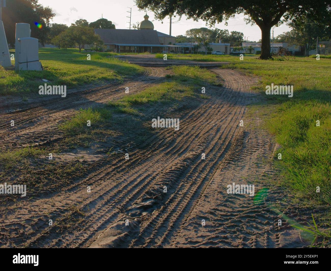Low view leading lines down a dirt road used by construction equipment ...