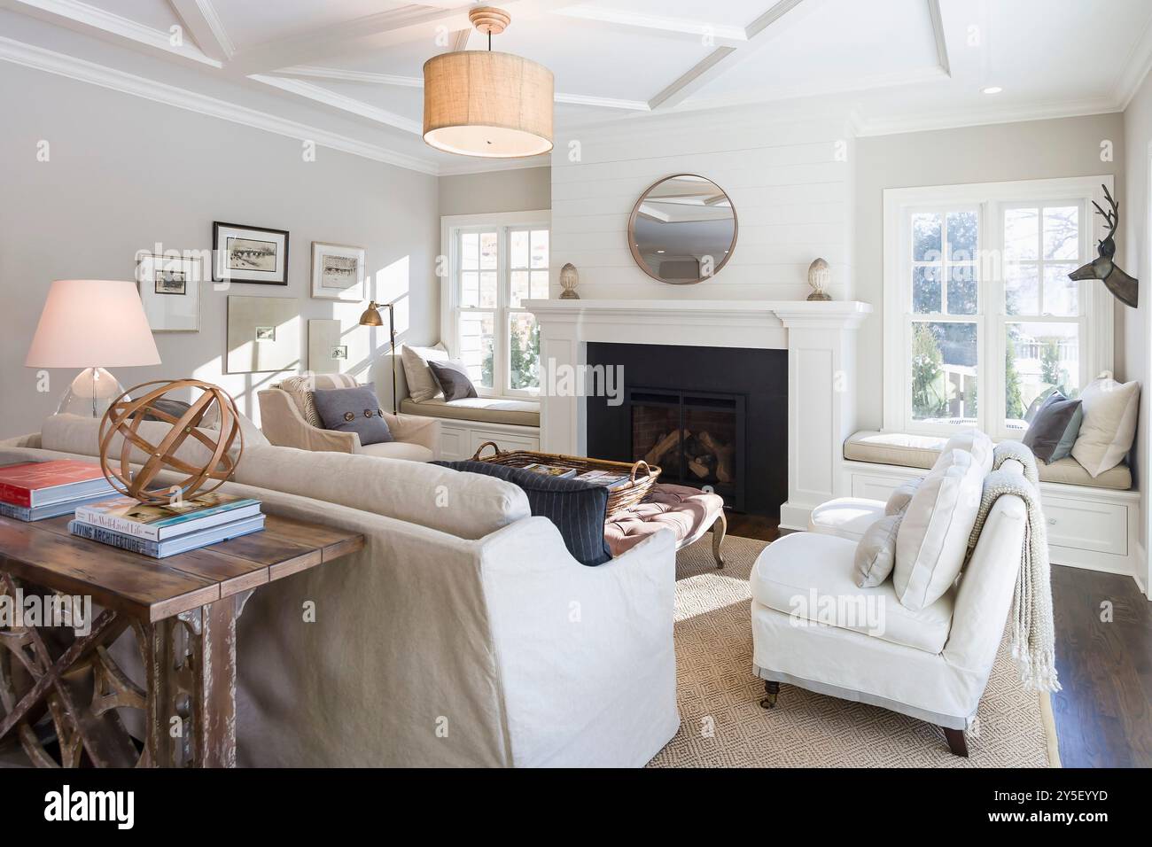 Beautiful white great room with coffered ceiling and white woodwork ...