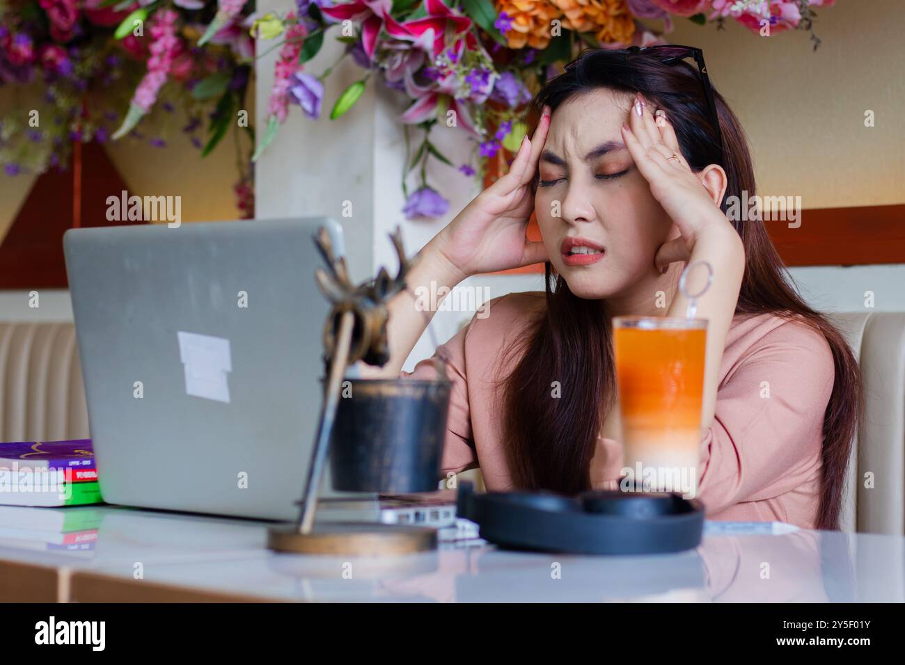 expression of beautiful adult asian female close eyes both hands hold aching head, severe ...