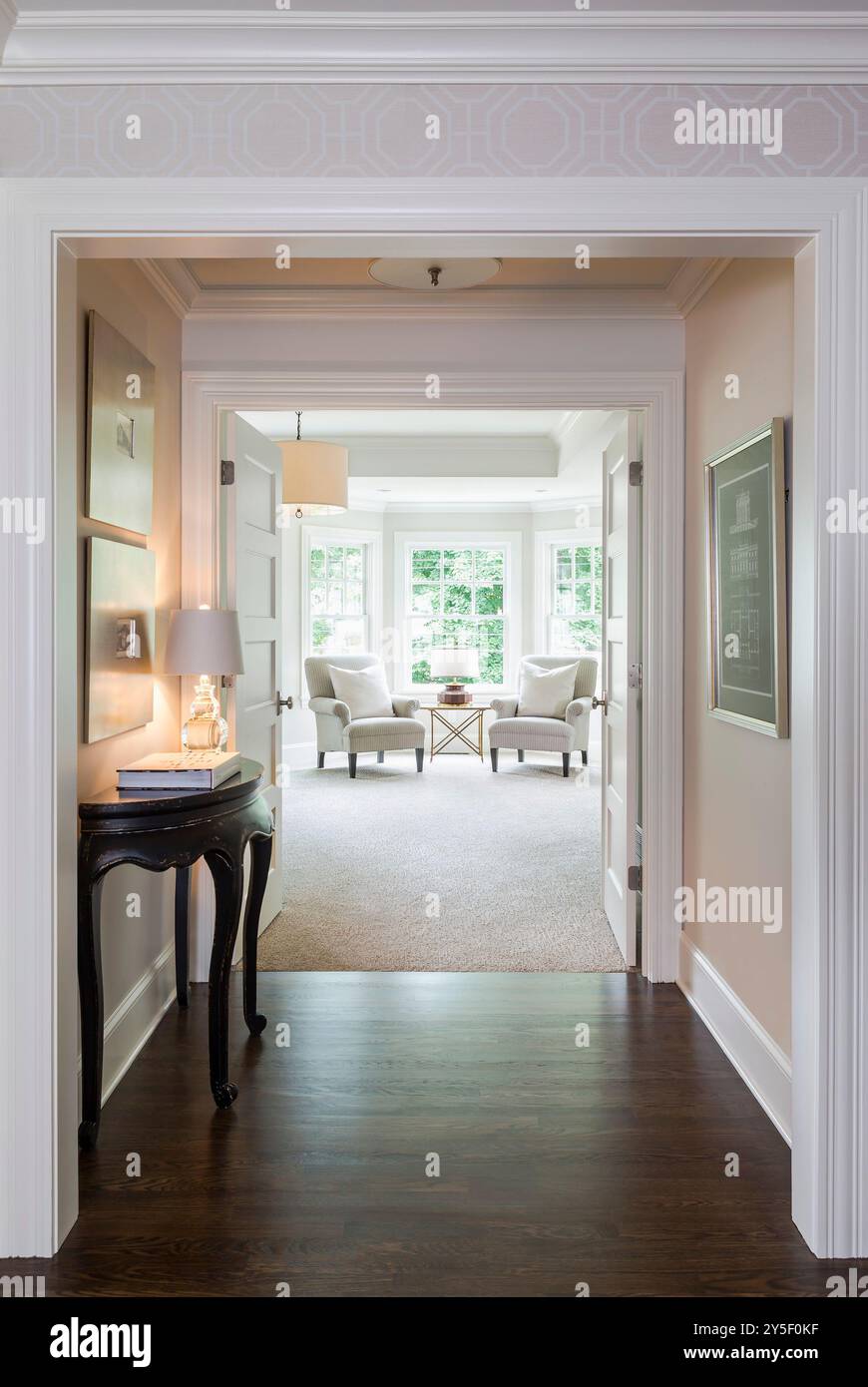 Entrance to master bedroom with double doors and small table and lamp ...