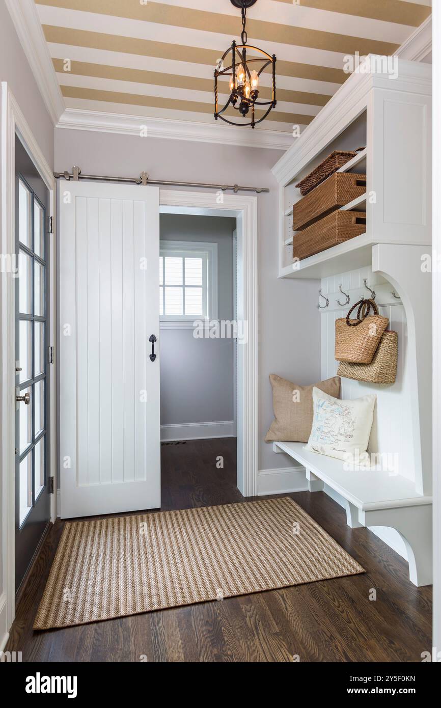 Back hallway of house with small mudroom area Stock Photo - Alamy
