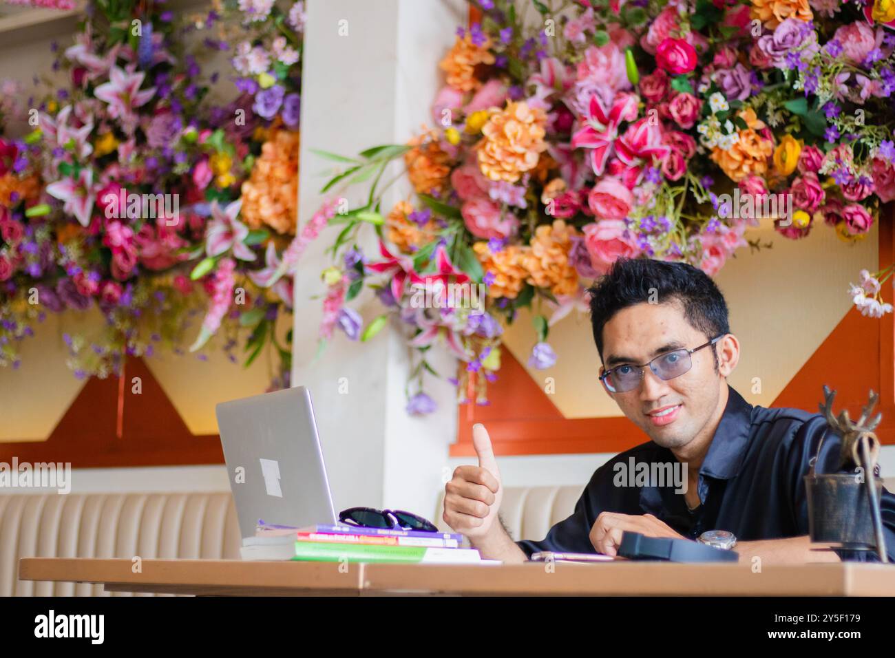 Asian male businessman to camera using laptop computer to work on ...