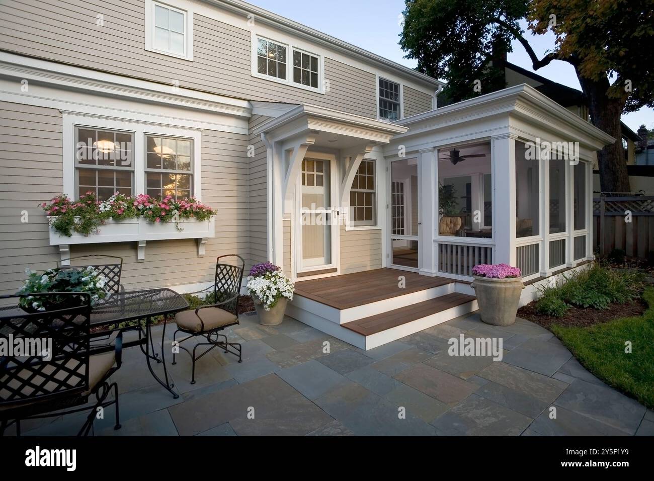 Back exterior of wood house showing back door, screened porch and slate ...