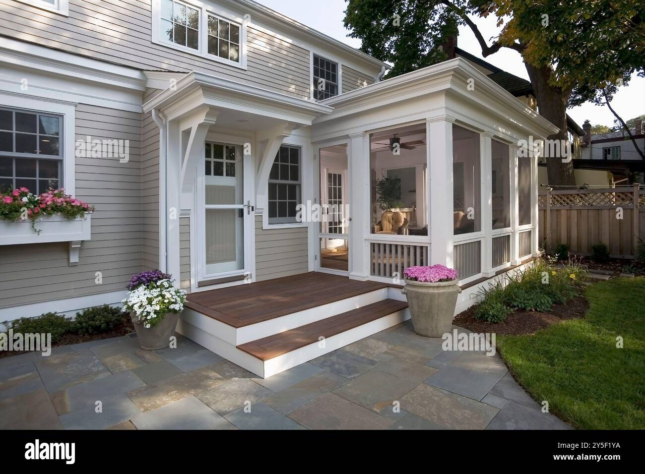 Back exterior of wood house showing back door and screened porch and ...