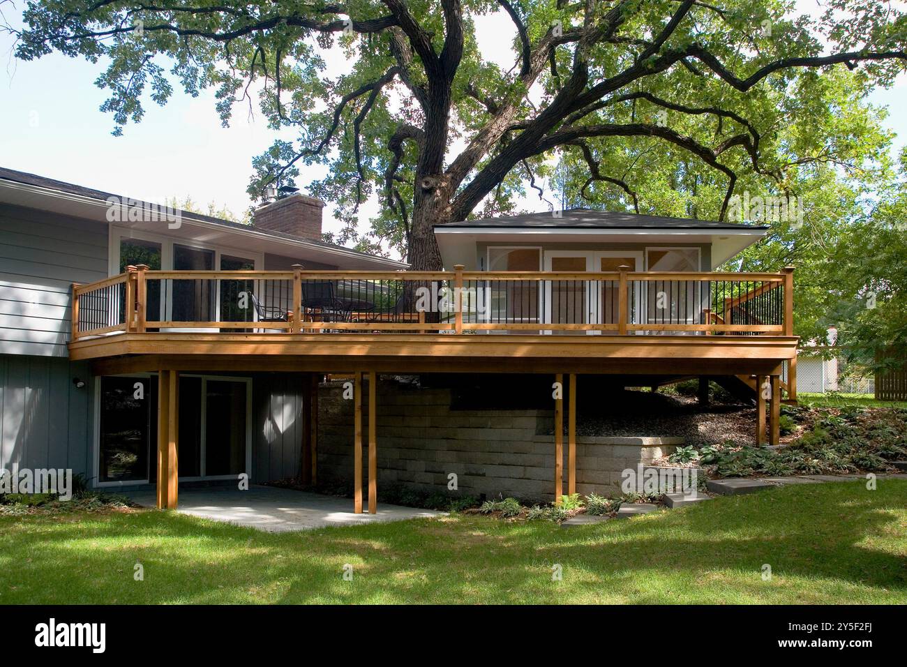 Back of split level house showing elevated deck and screened porch ...