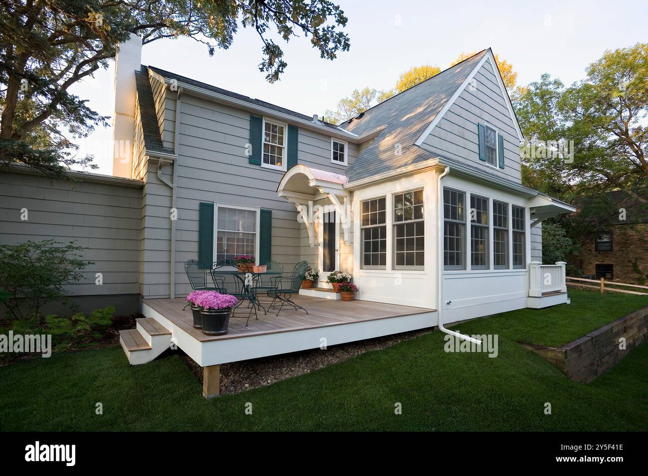 Back exterior of remodeled house showing addition and deck Stock Photo ...