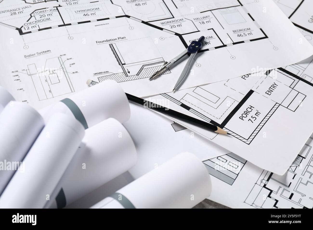 Different engineering drawings, pencil and divider on table, closeup ...