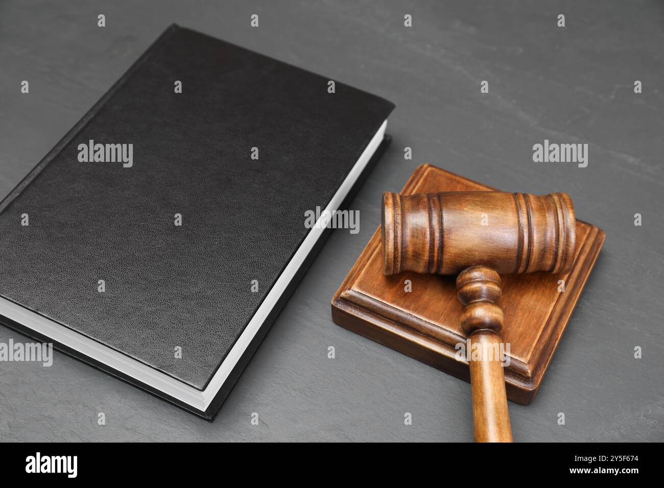 Book and judge's gavel on gray textured table Stock Photo - Alamy