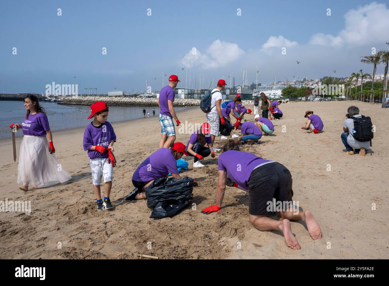 Volunteers seen collecting waste and garbage on the seashore during a ...