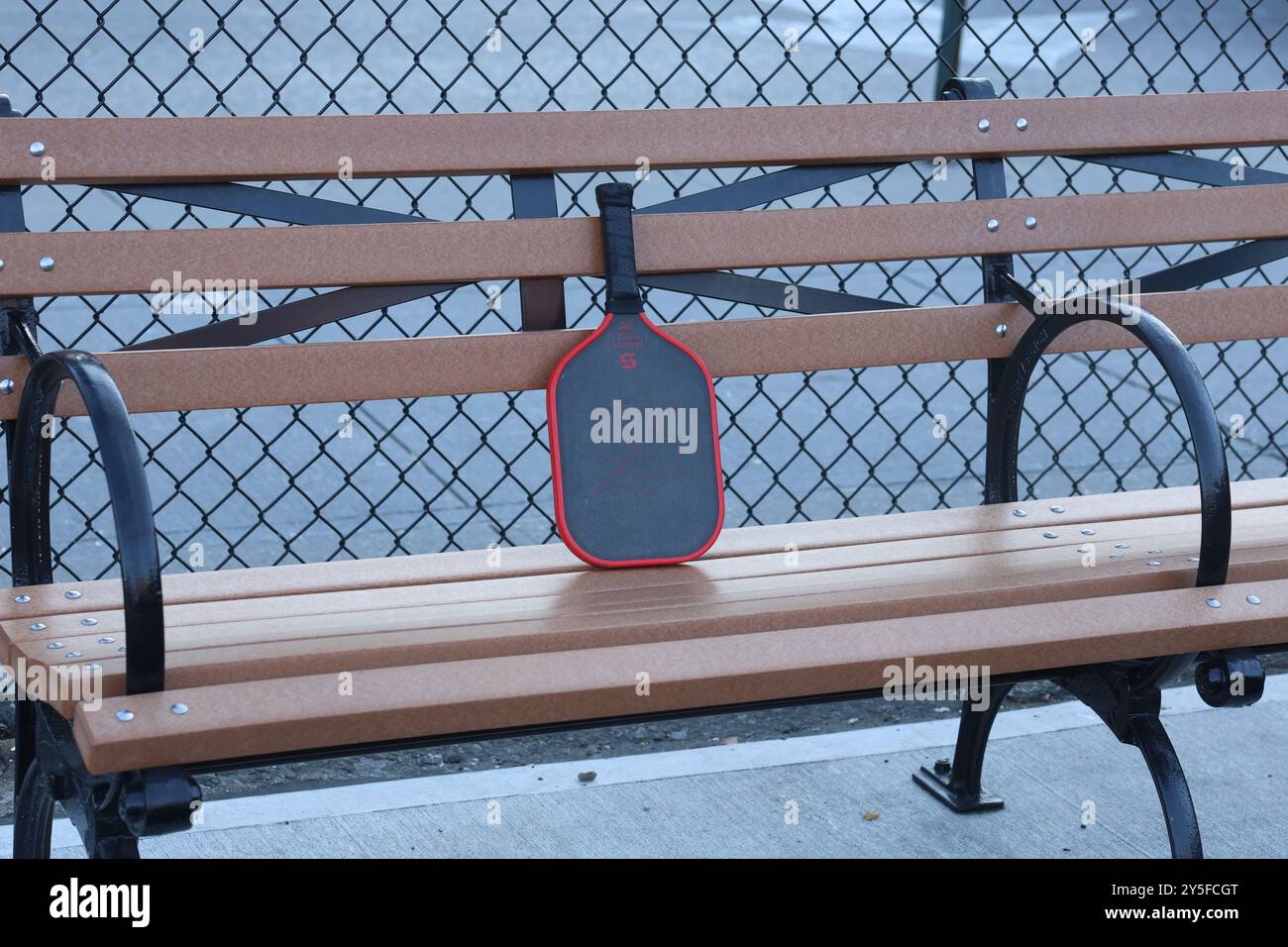 Pickleball paddle on bench near Pickleball court in New York City Park ...