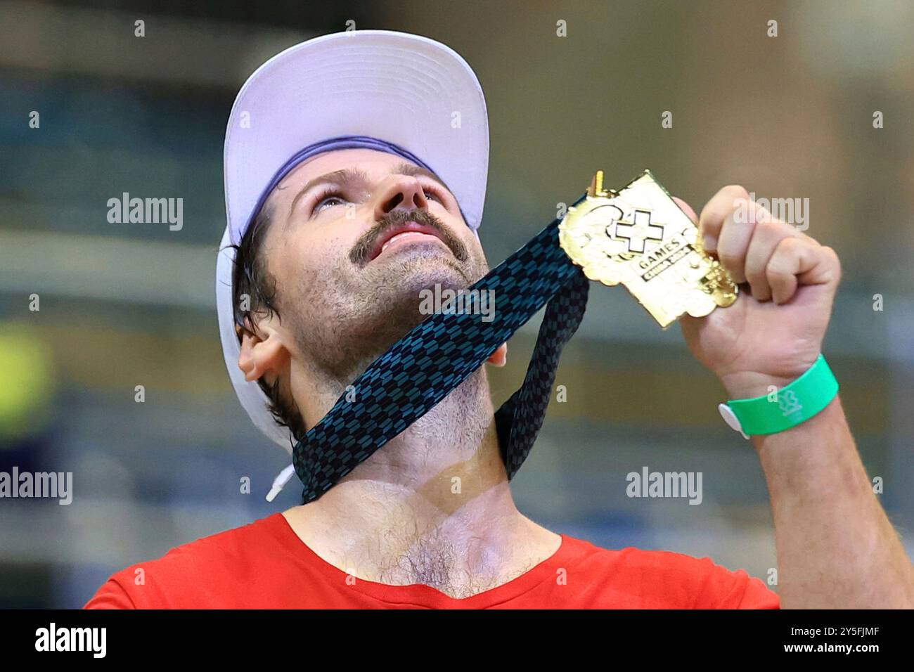 Garrett Reynolds of the USA reacts with his gold medal during an award ...