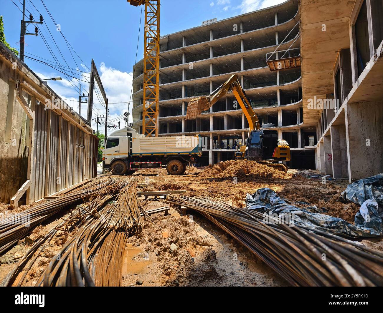 Excavator loads ground into a dump truck at a construction site Stock ...